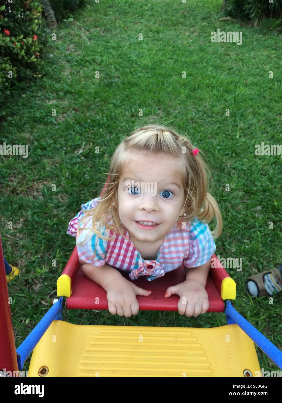 Cute little girl playing outside Stock Photo - Alamy