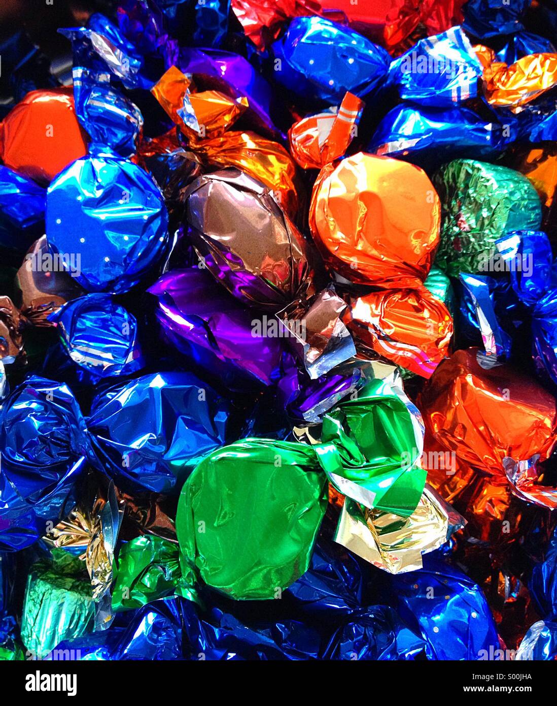 Multicolored candies in bright wrappers Stock Photo - Alamy
