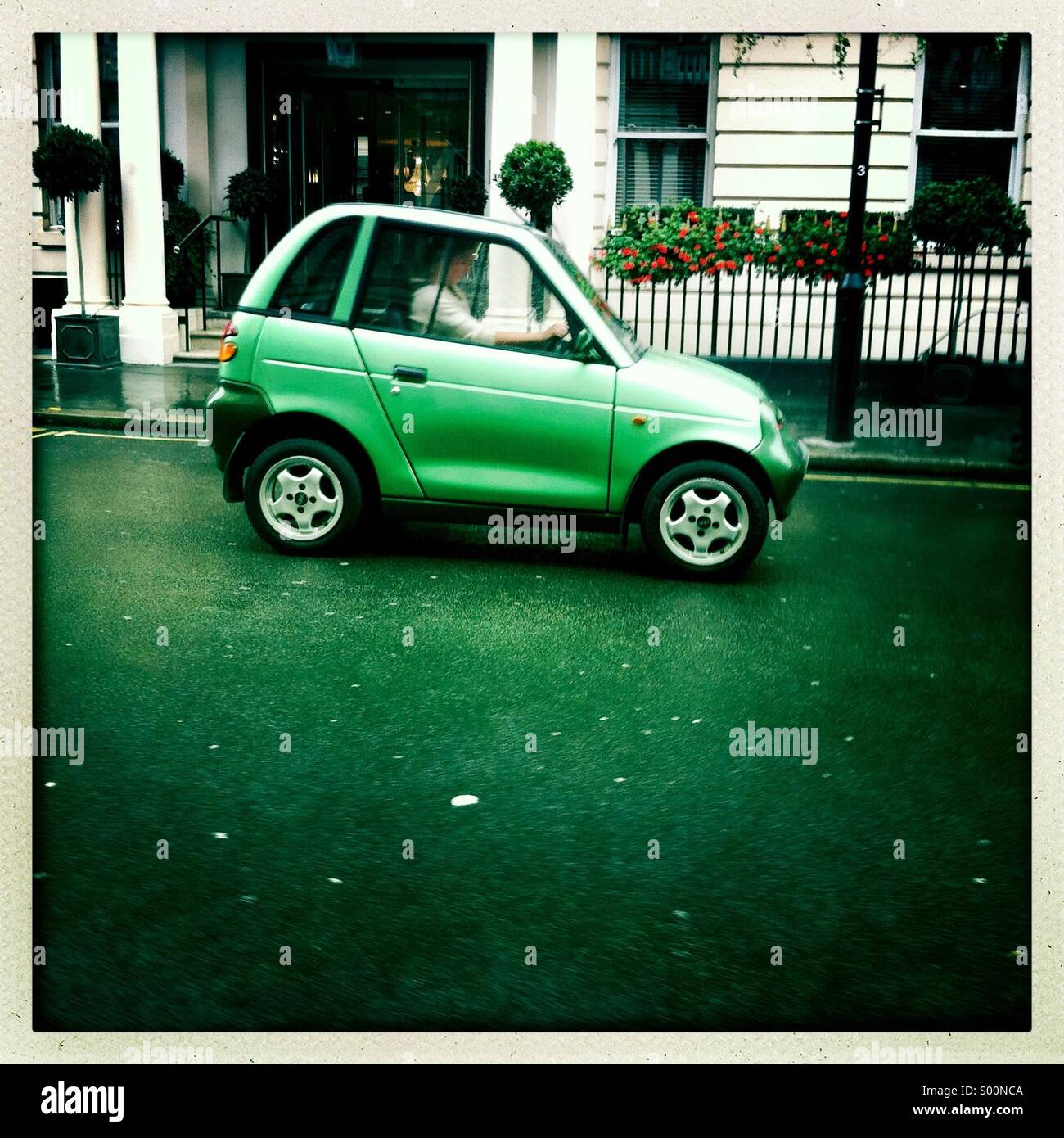 A woman driving a green smart car in London England UK Stock Photo - Alamy