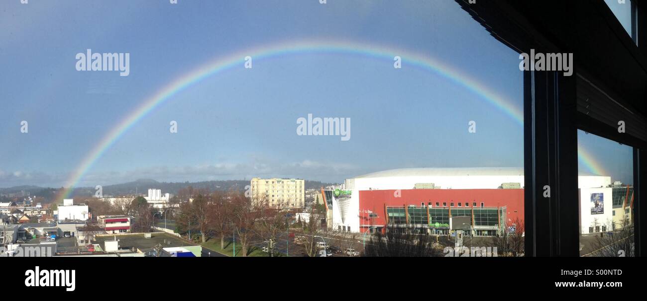 Full rainbow from office window Stock Photo - Alamy