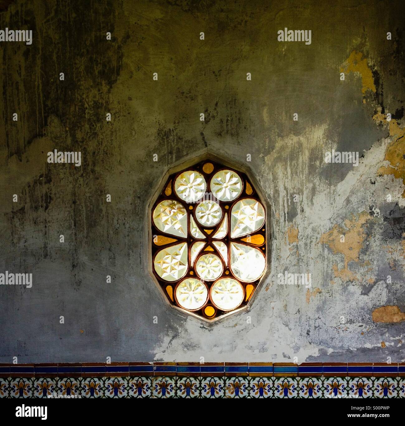 Stained glass window, distressed wall and tiles Stock Photo - Alamy