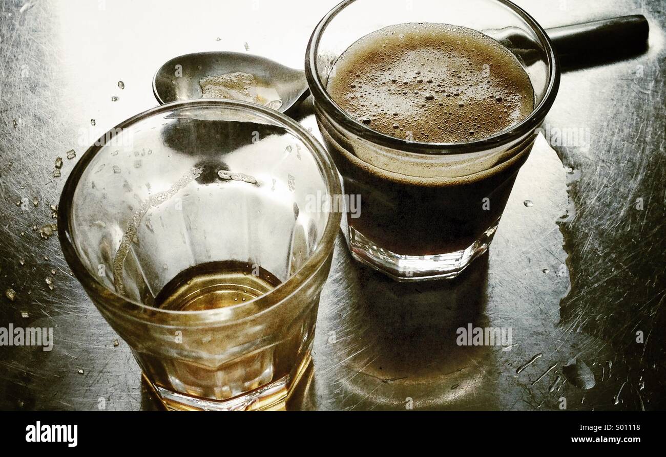 Two espresso intense coffee shots on a stainless steel serface Stock ...