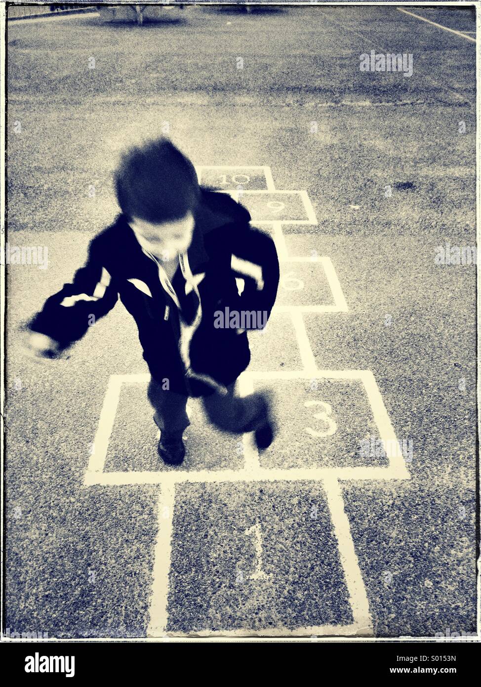 Child playing hopscotch Stock Photo - Alamy