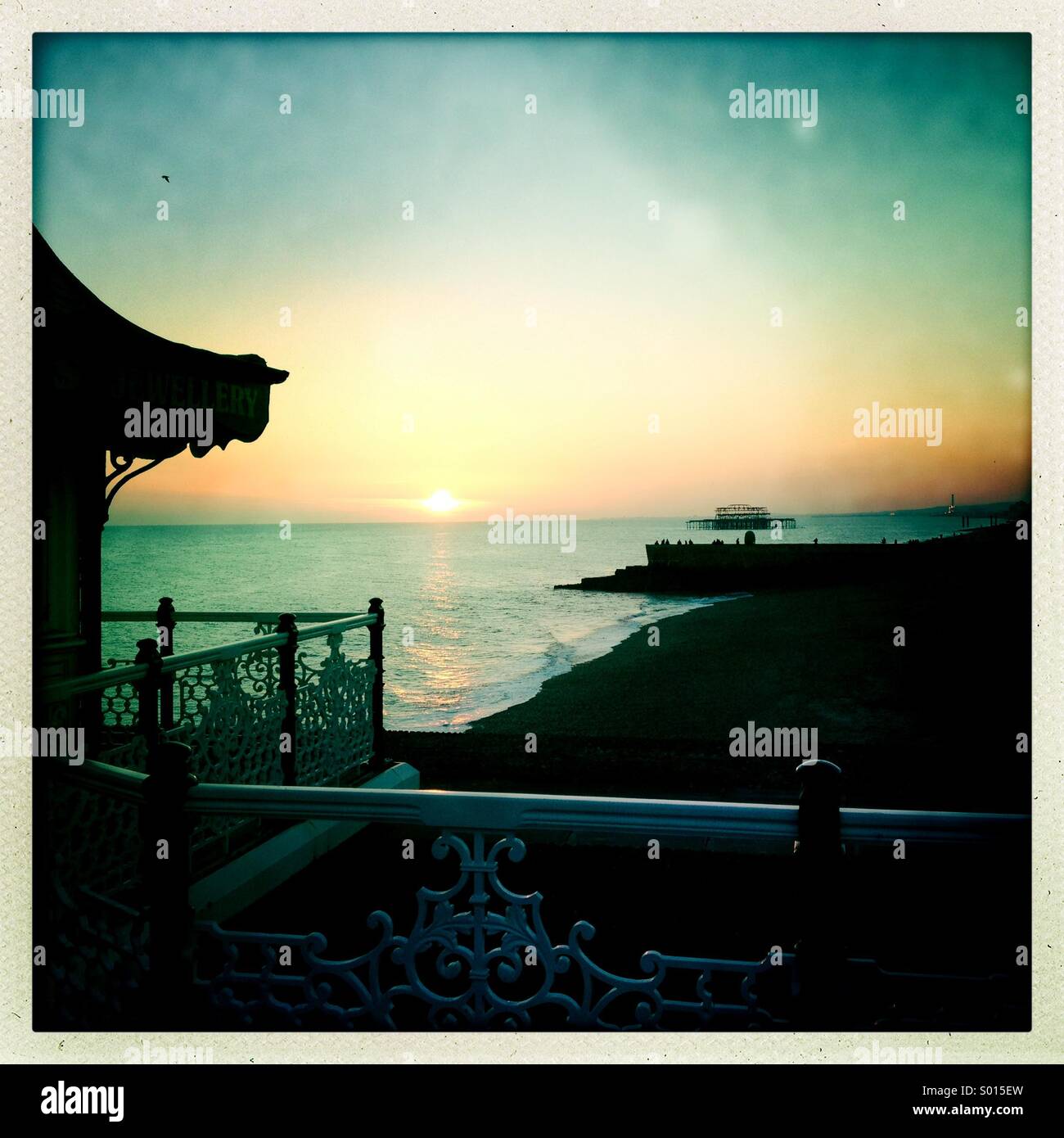Sunset at Brighton pier with old pier in background Stock Photo - Alamy