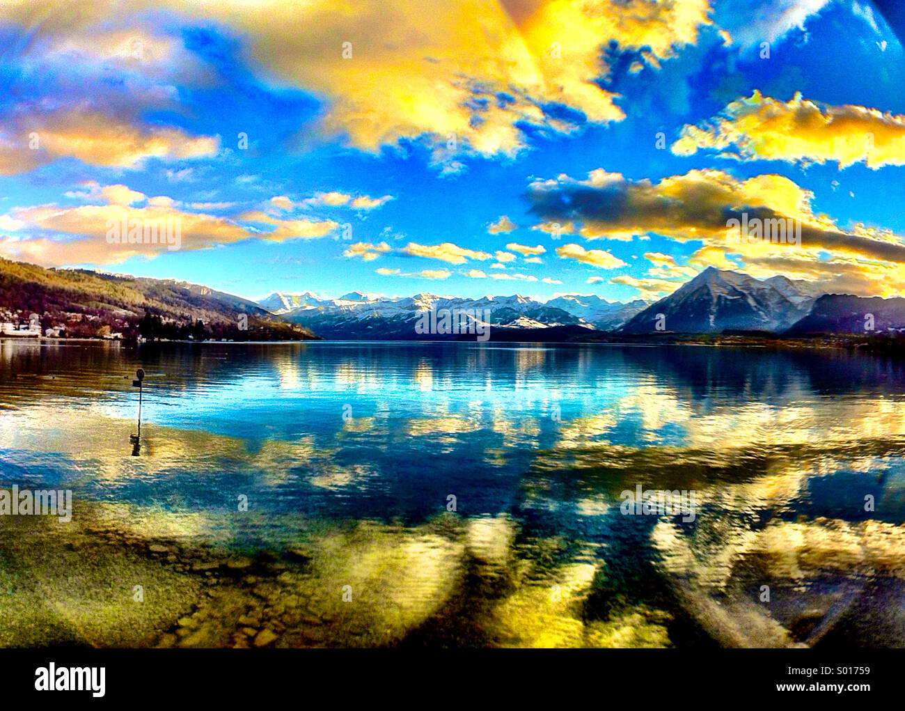 Winter sunset reflected in Lake Thun Stock Photo - Alamy