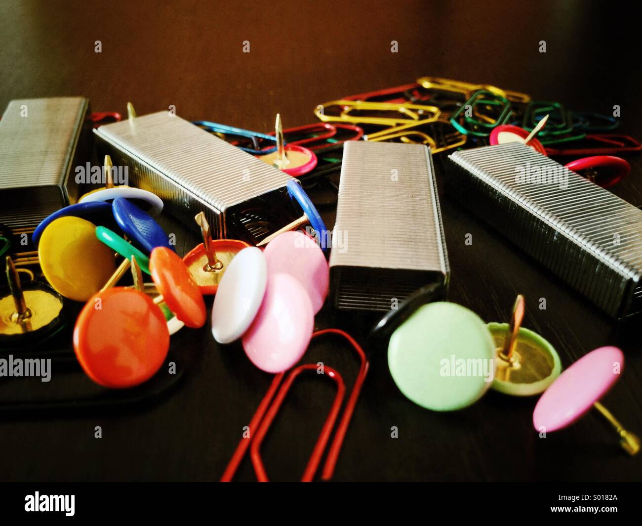 Colorful paper clips, staples and thumbtacks Stock Photo - Alamy