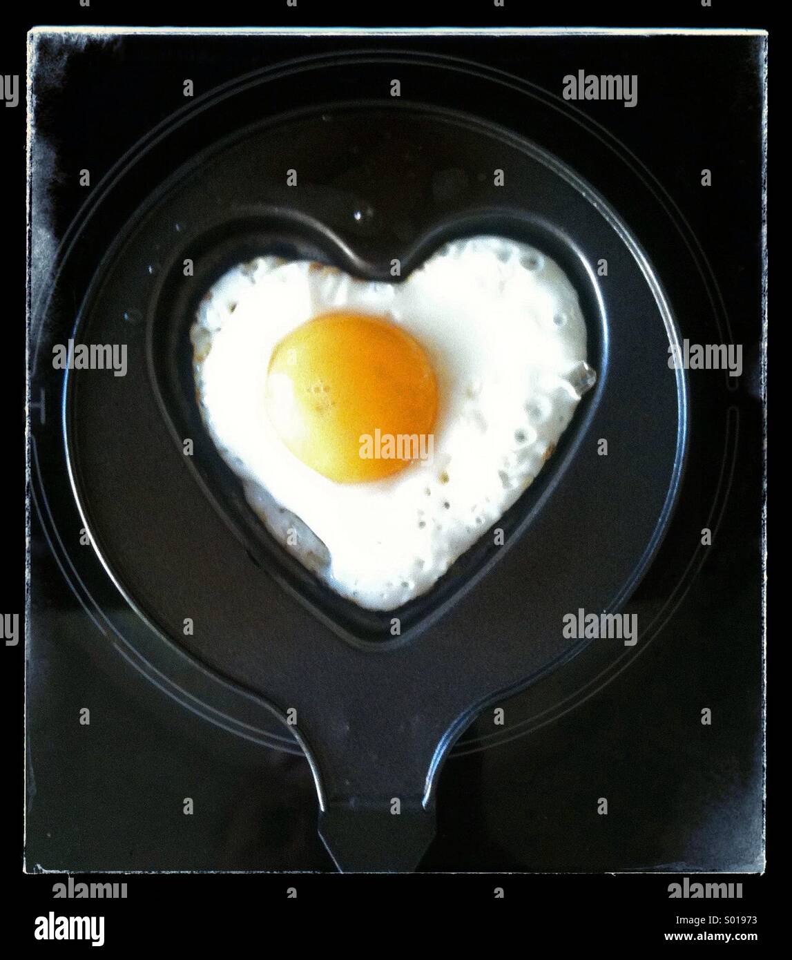 Heart shape fried egg Stock Photo - Alamy