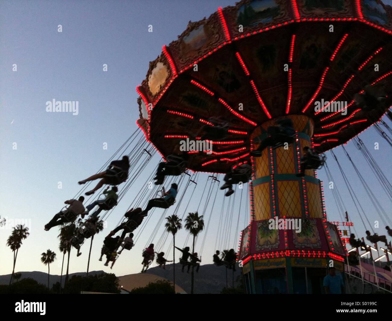 Swinging fun at the fair Stock Photo - Alamy