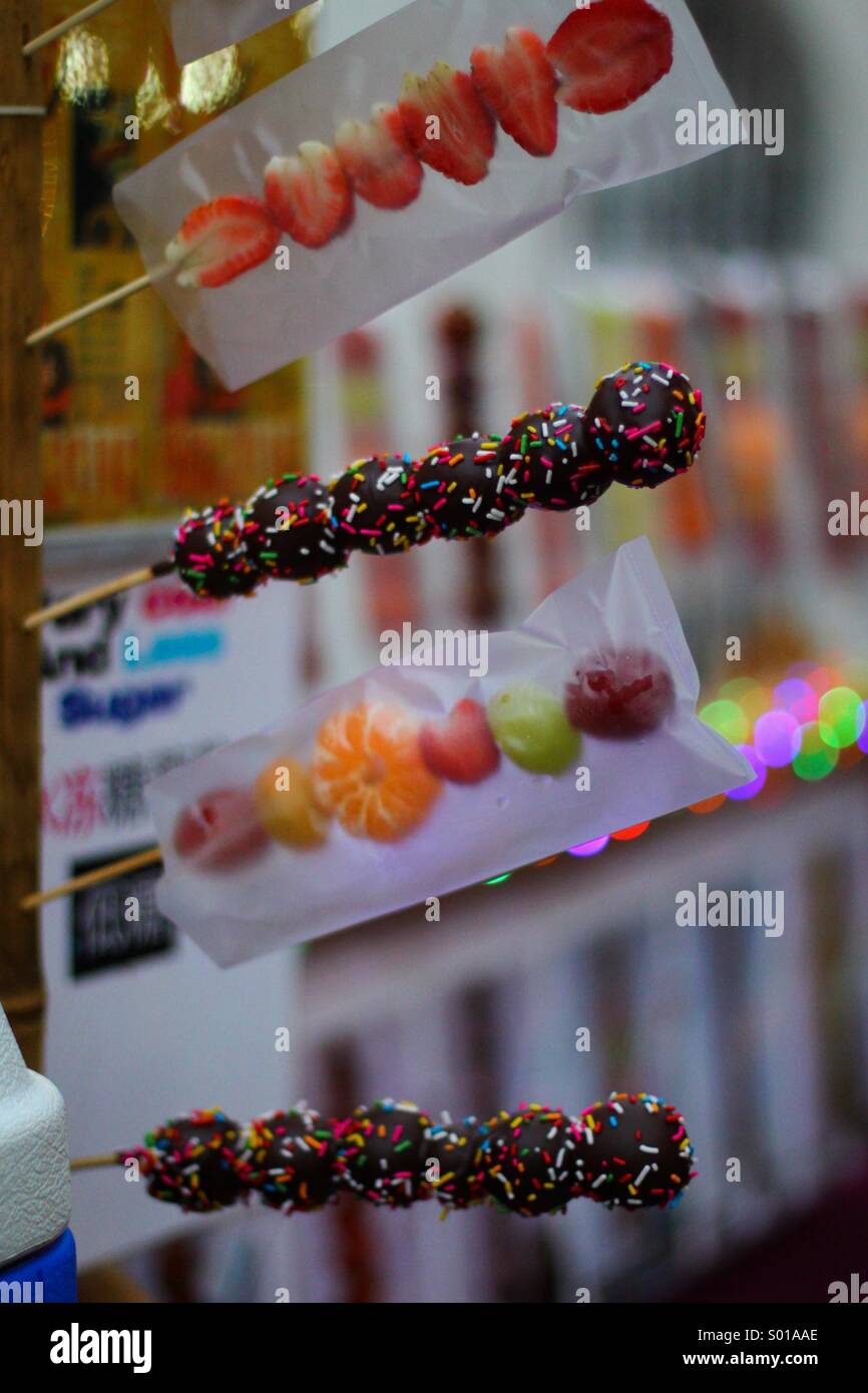 Covering fruit with chocolate Stock Photo - Alamy