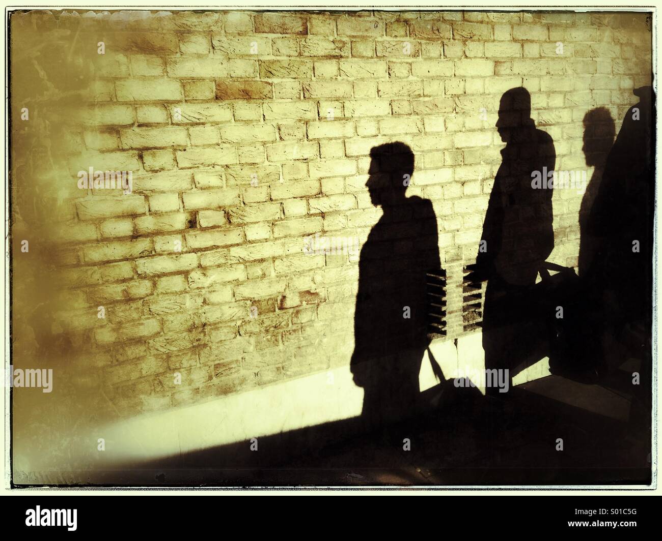 Shadows of three people on brick wall,Shoreditch,London ,UK Stock Photo ...