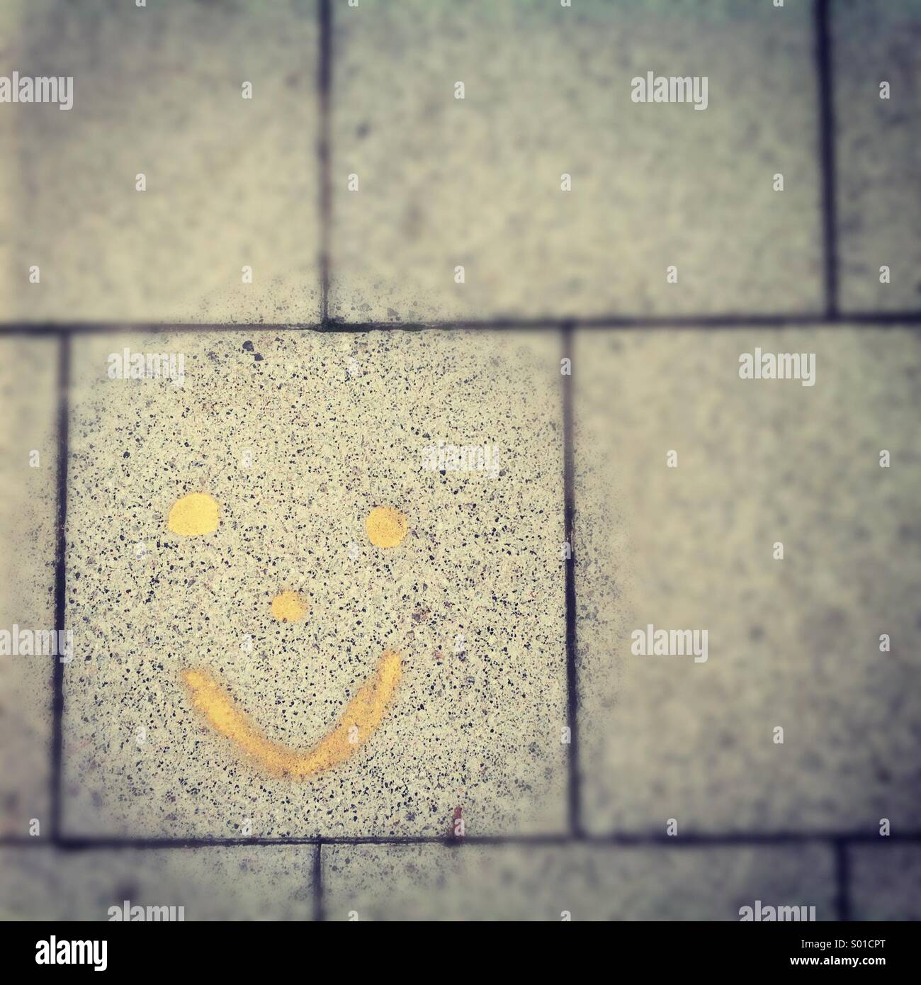 Smiley graffiti on the pavement Stock Photo - Alamy