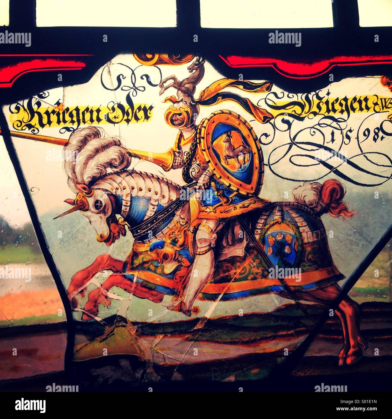 A stained glass window with a knight on a horse Stock Photo - Alamy