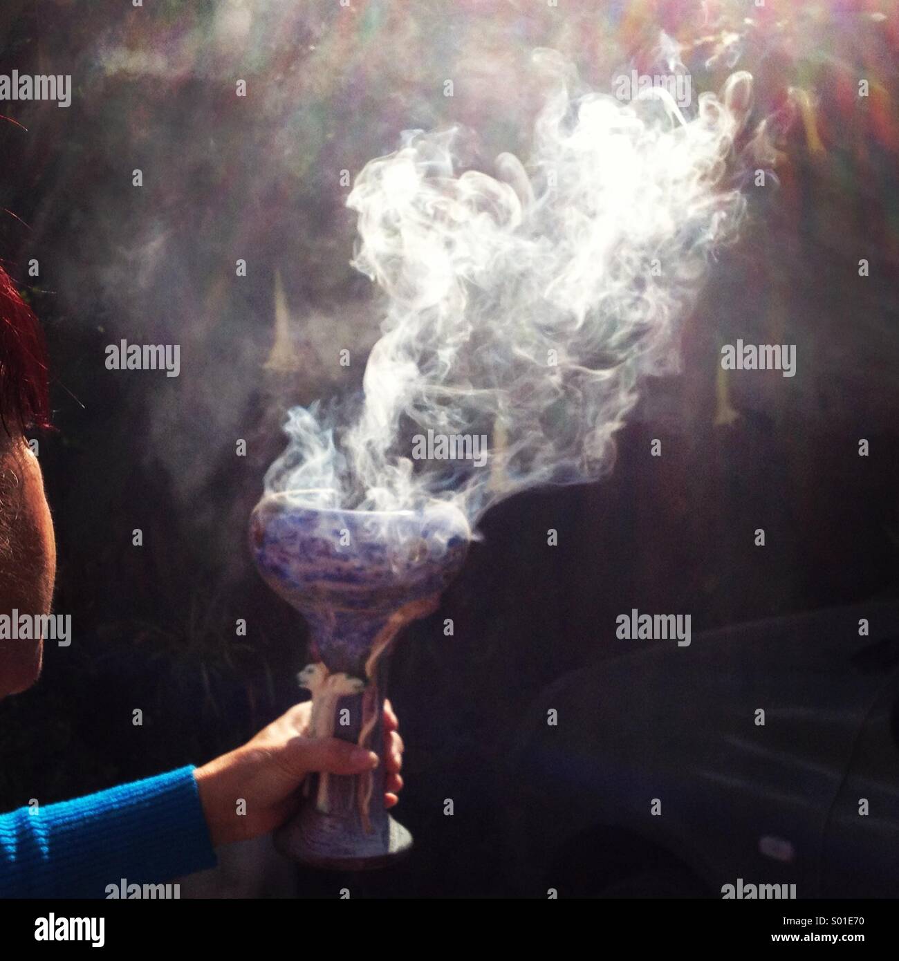 A woman spreads incense during a temaxcal ritual in Mexico City, Mexico ...