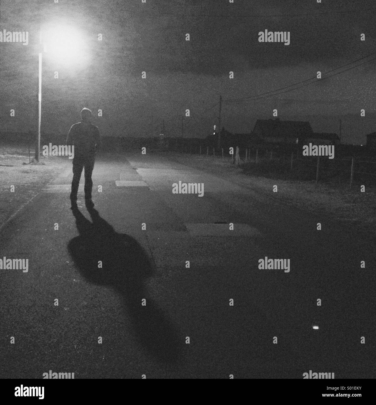 Man standing under street light Black and White Stock Photos & Images ...