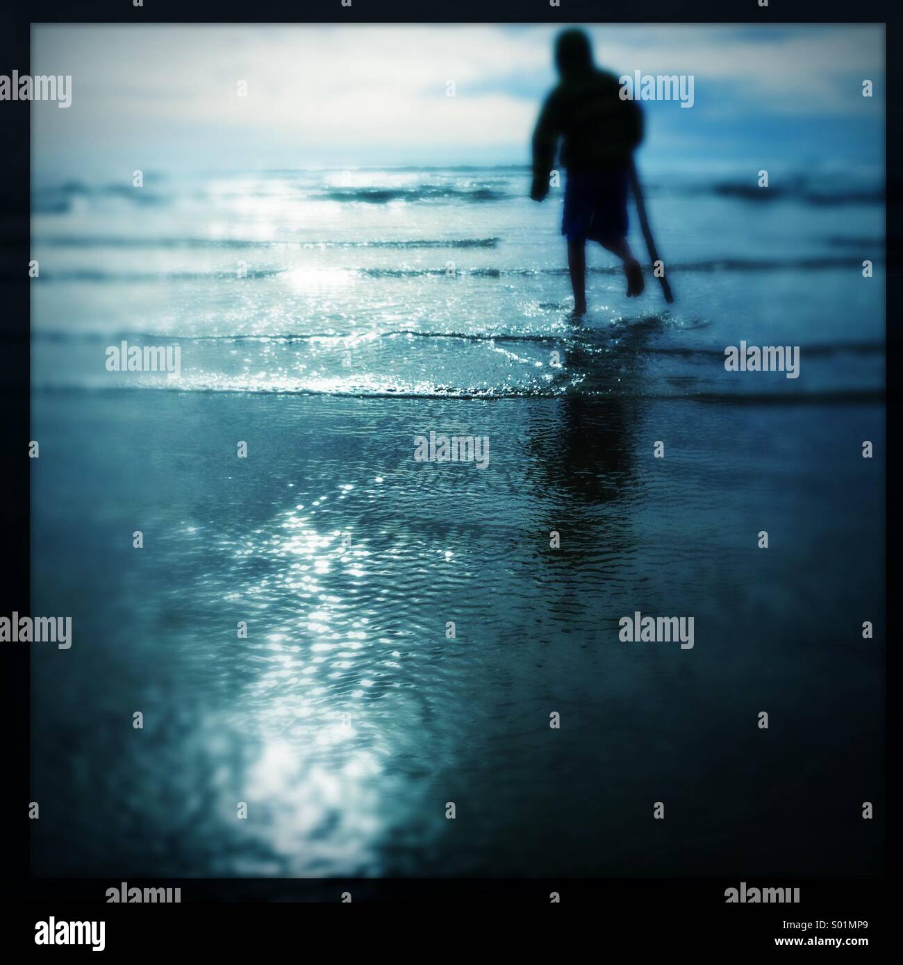 Boy running into surf hi-res stock photography and images - Alamy