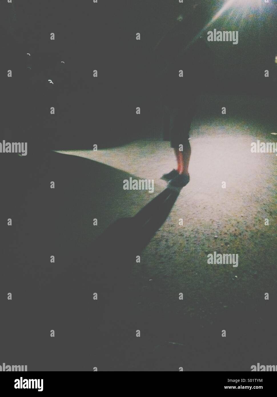 Man standing in shadows Stock Photo - Alamy