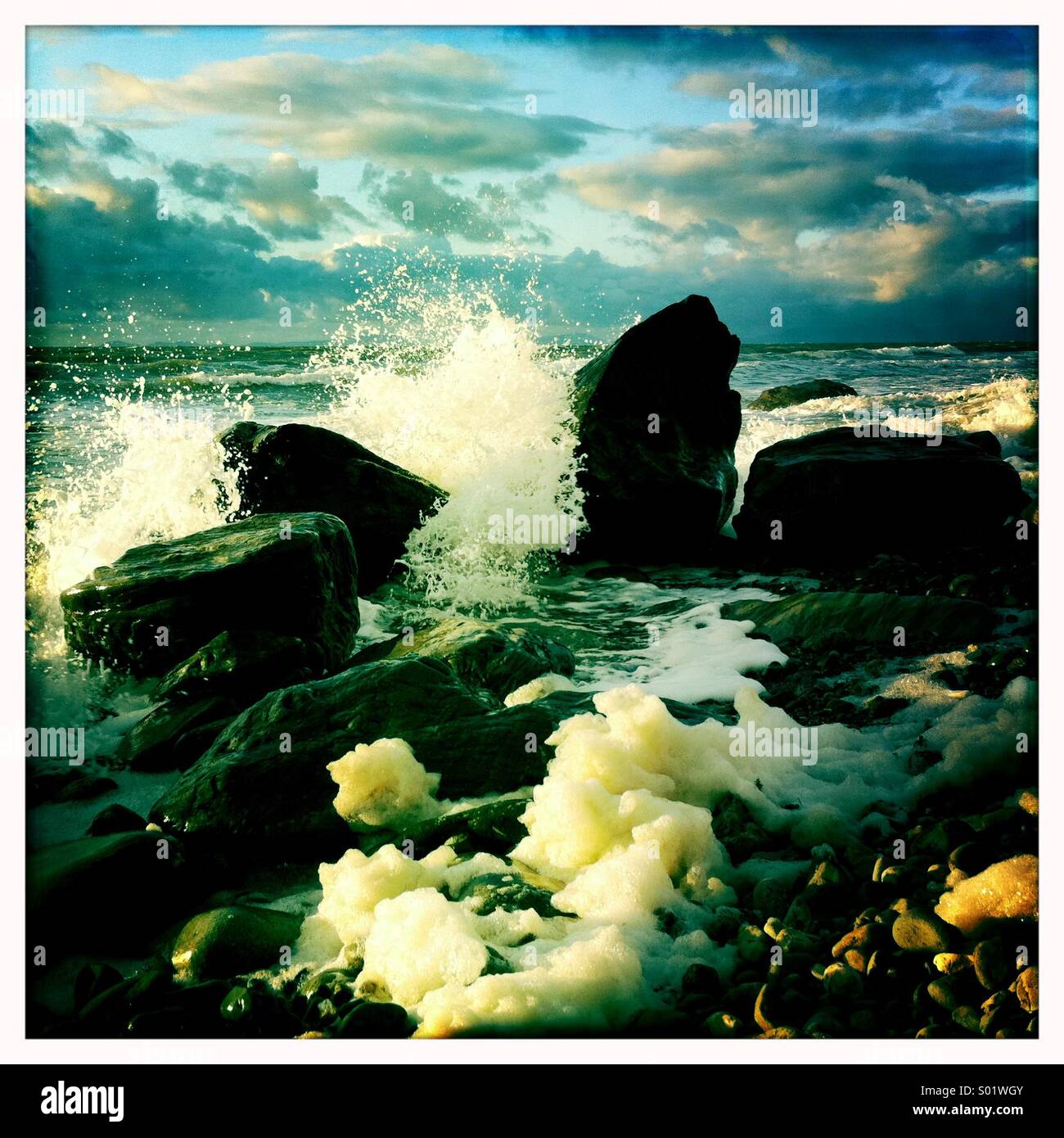 Waves crashing onto rocks Stock Photo - Alamy