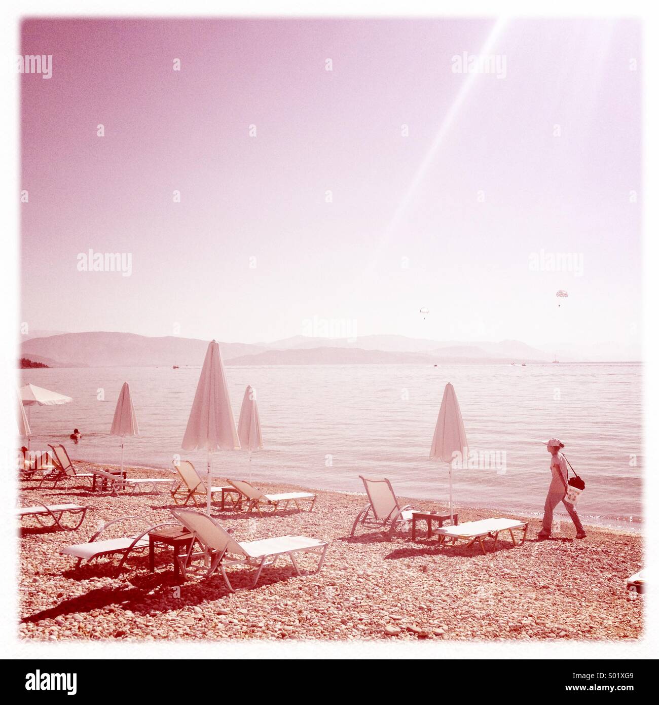 Sun beaming down on Greek beach Stock Photo - Alamy