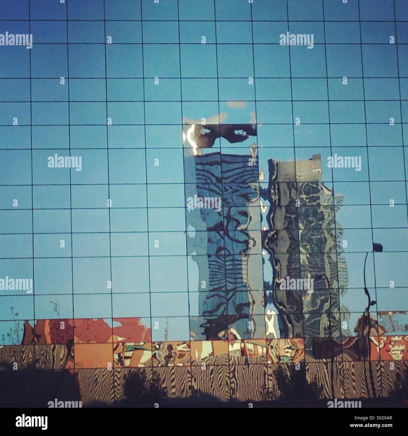 Four towers reflected in a building Stock Photo - Alamy