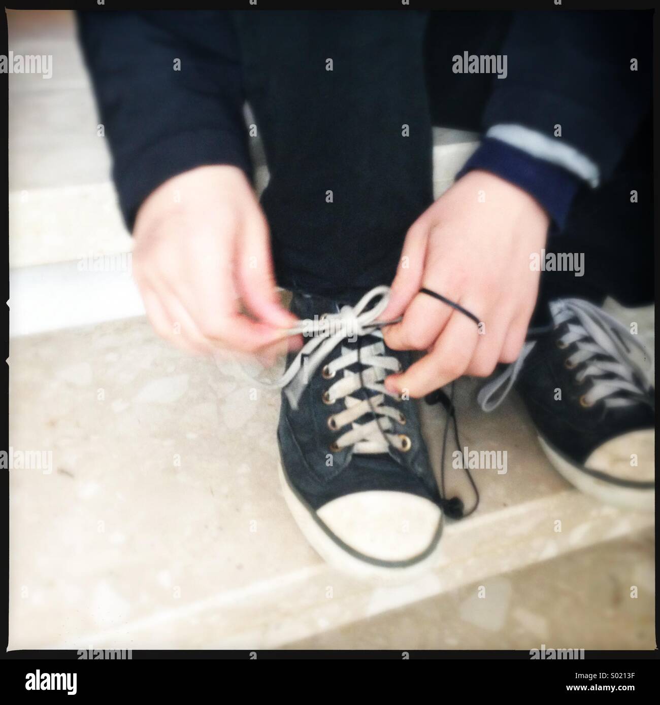 Boy fasten his shoes Stock Photo - Alamy