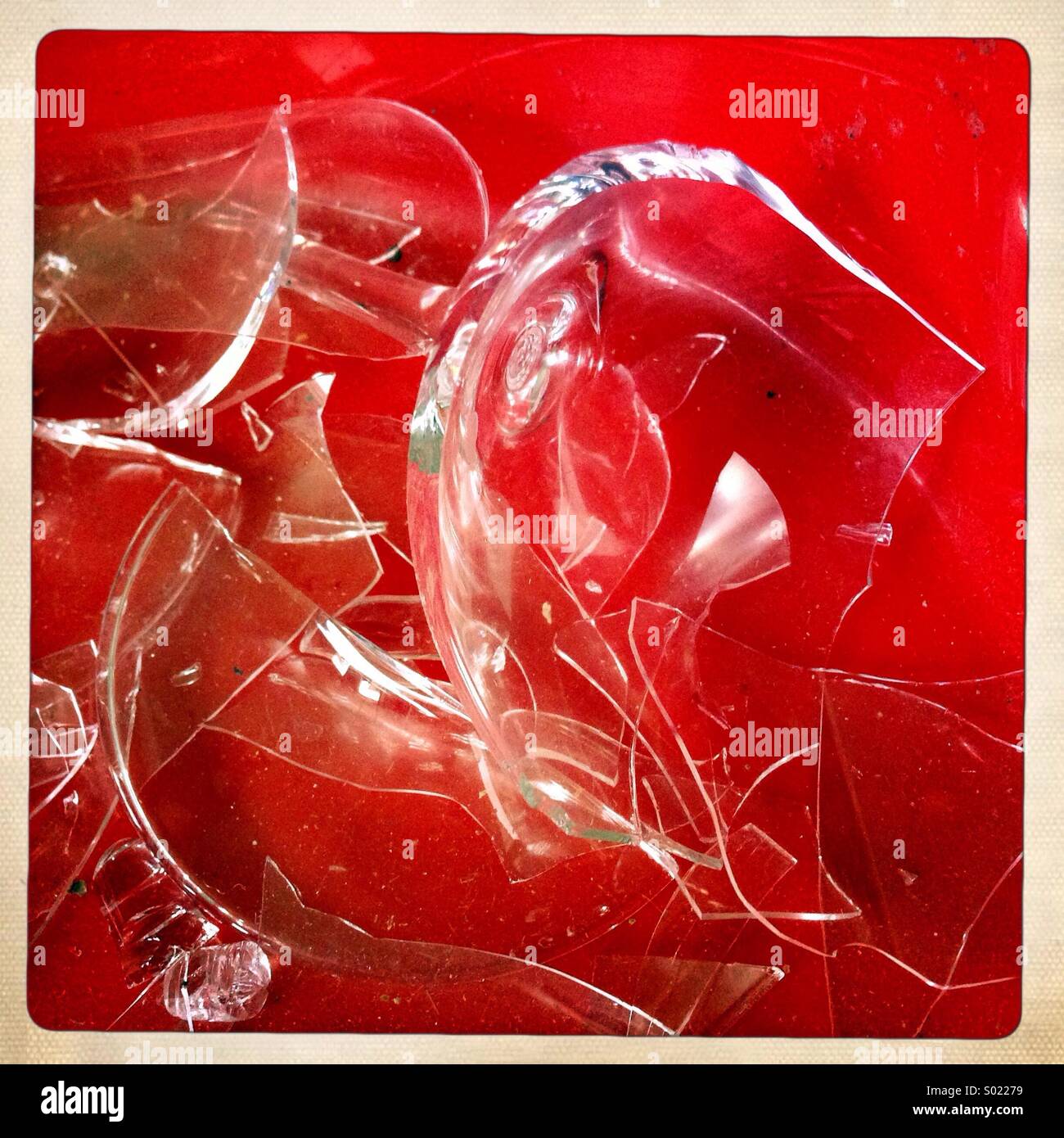 Pieces of broken glass on red Stock Photo - Alamy