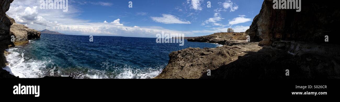 Cave, Crete, view from cave, ocean lapping at rocks cave, blue sky, sea ...