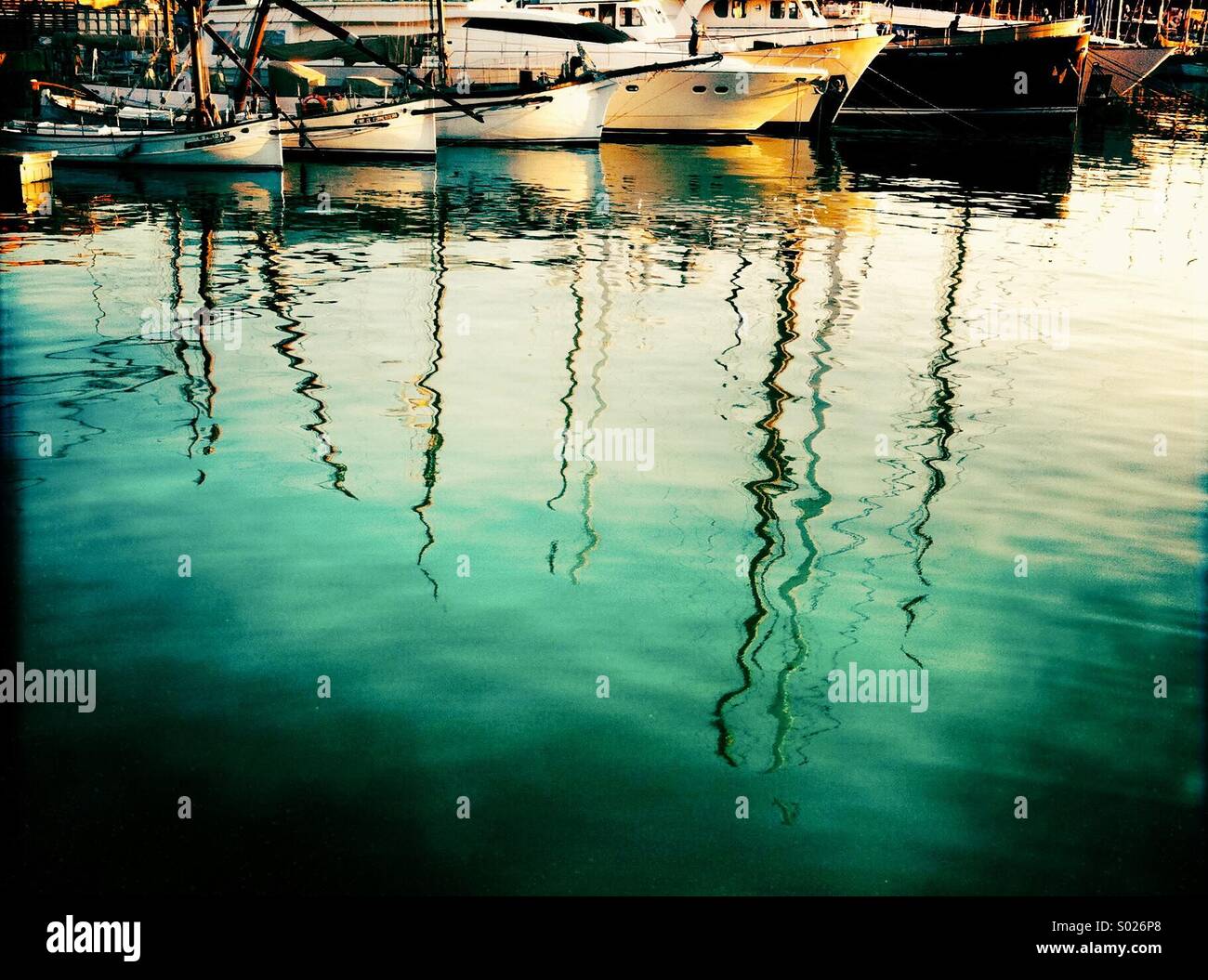 Boat reflections in harbour Stock Photo - Alamy