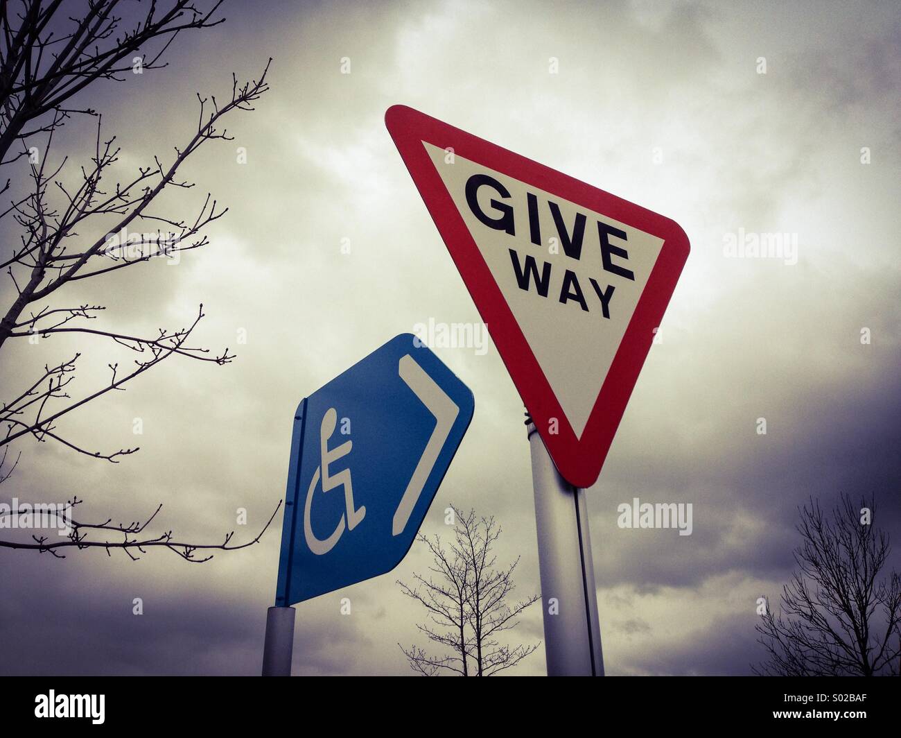 Give way and disabled signs Stock Photo - Alamy