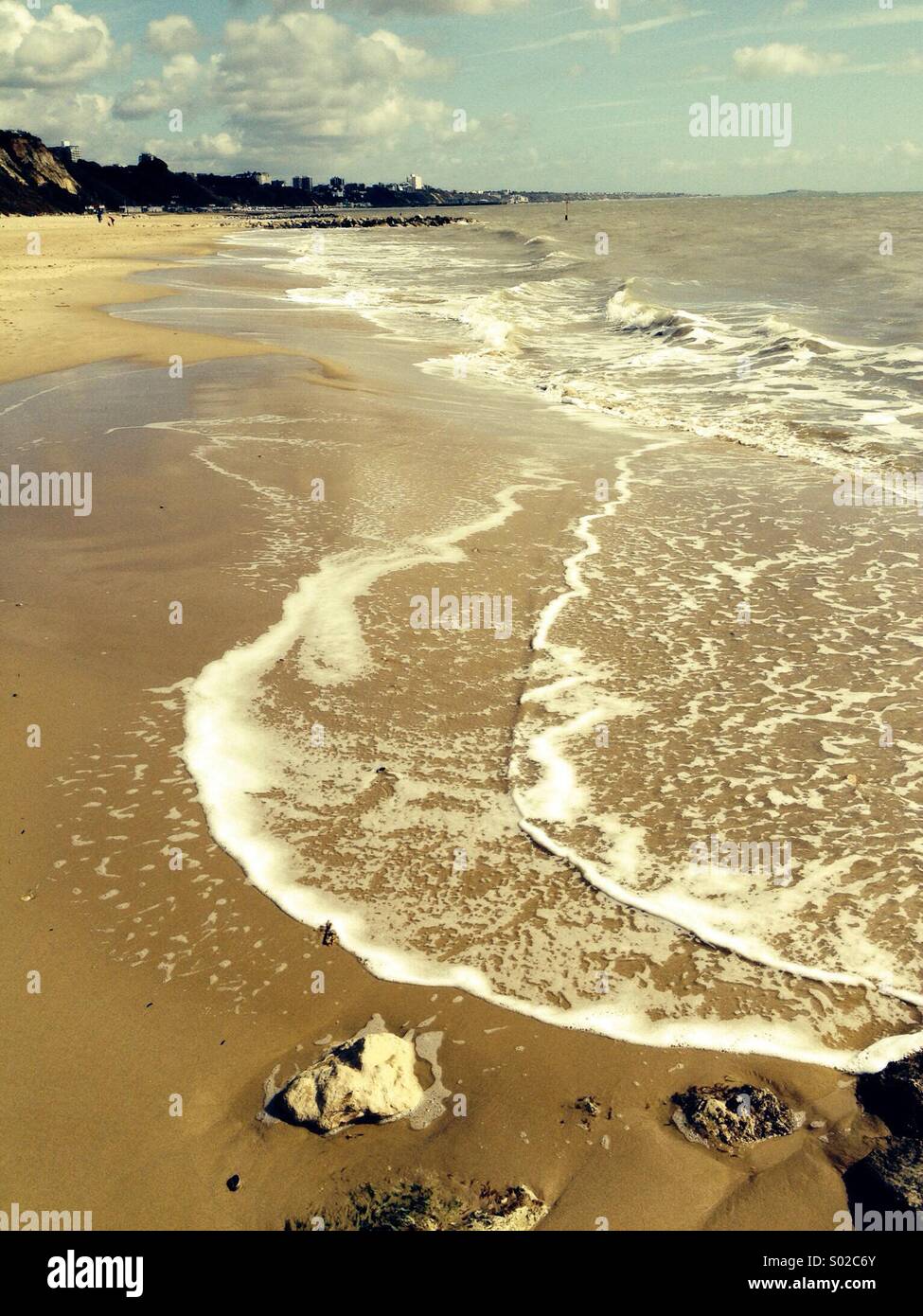 Waves of Incoming tide on beach at Bournemouth, UK Stock Photo - Alamy