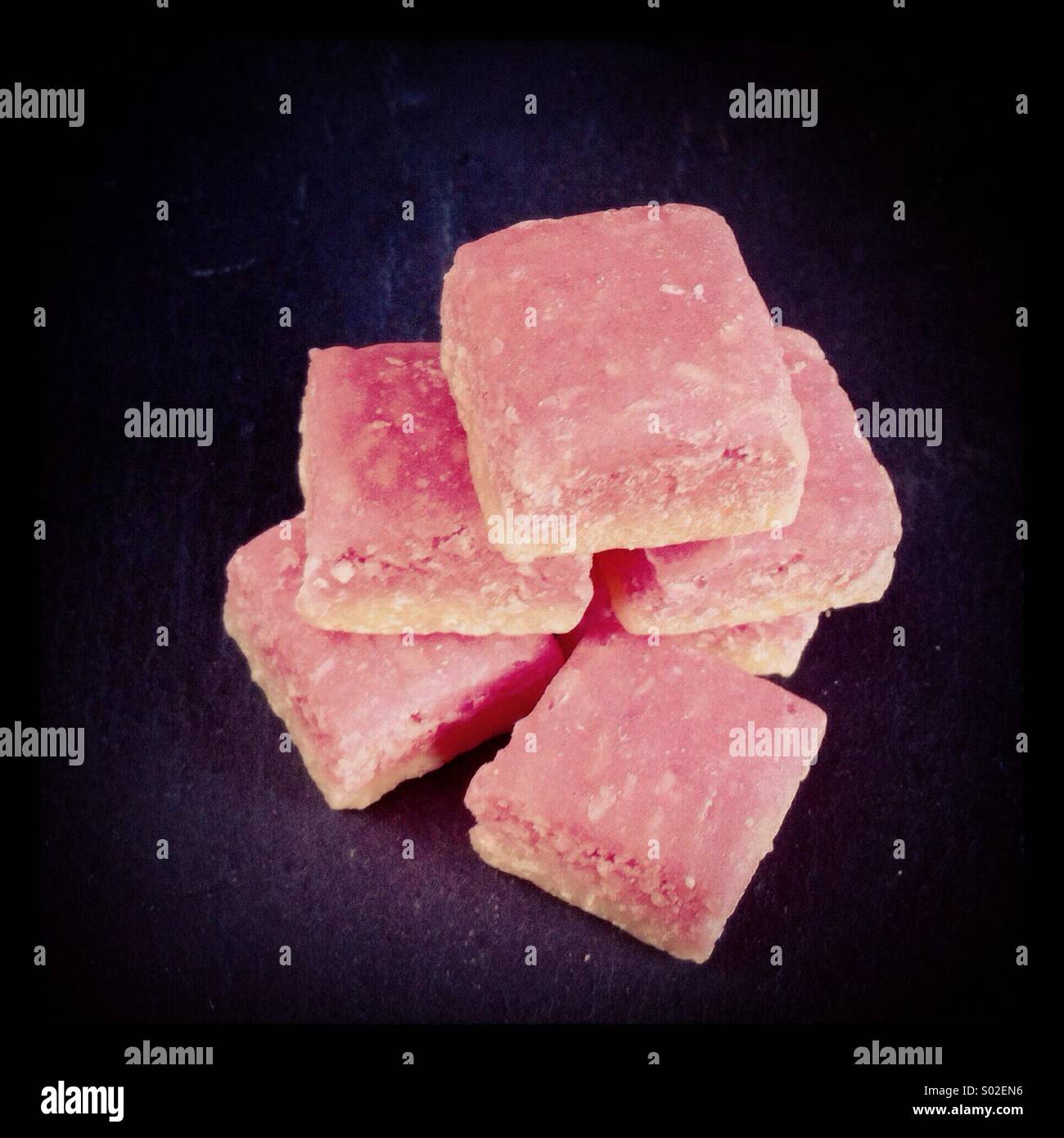 A pile of pink and white coconut ice Stock Photo - Alamy