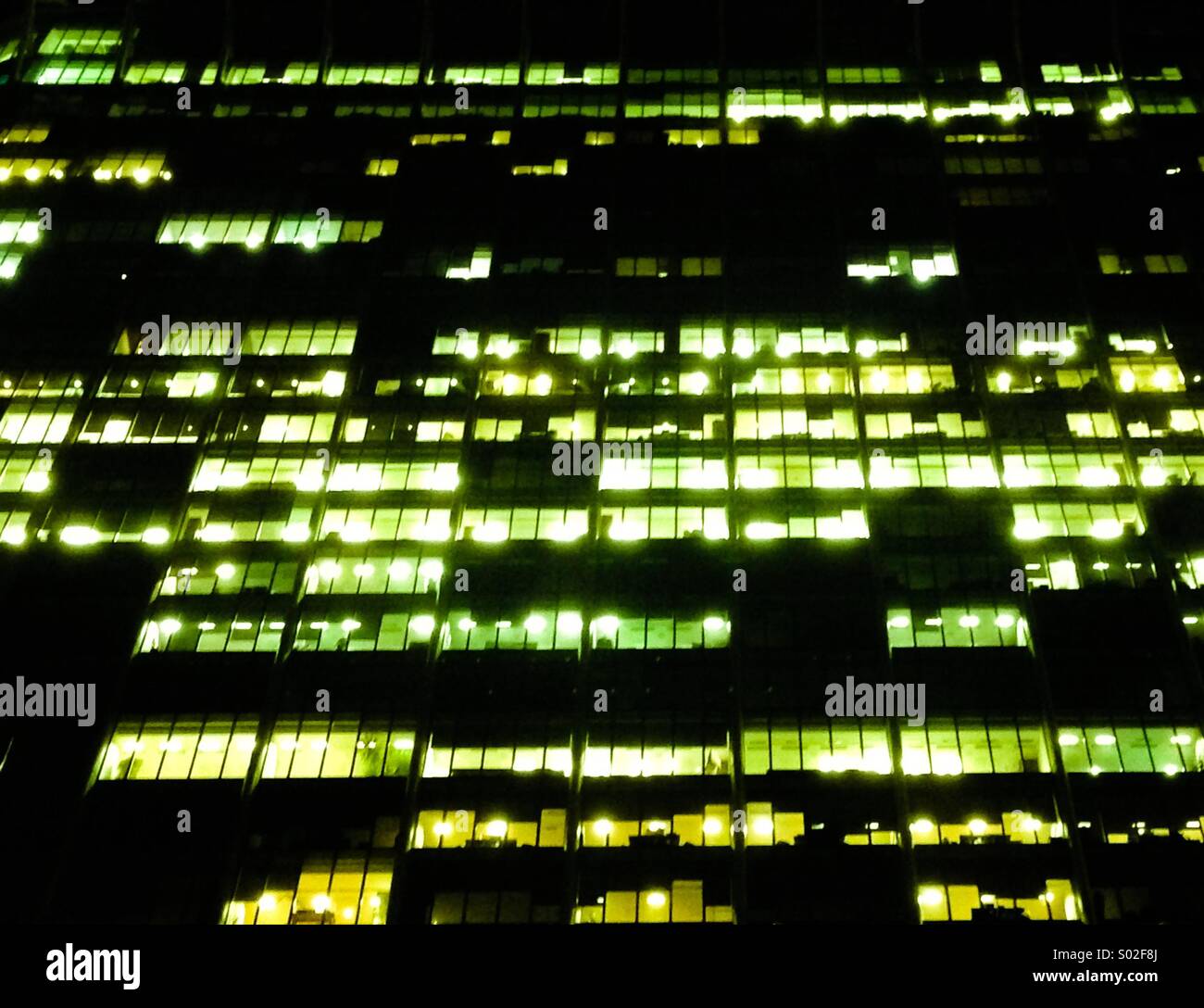Office block with lights on Stock Photo - Alamy