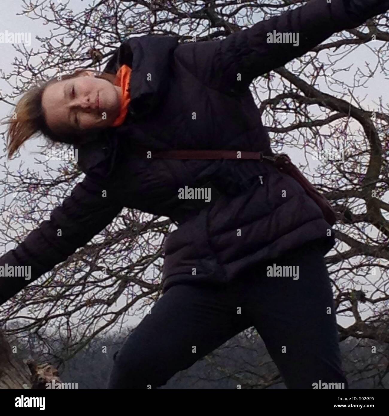 Young woman in a tree Stock Photo - Alamy