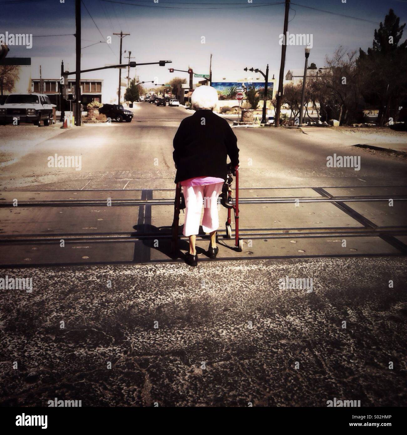 Elderly woman crossing railroad tracks with the help of a walker Stock ...