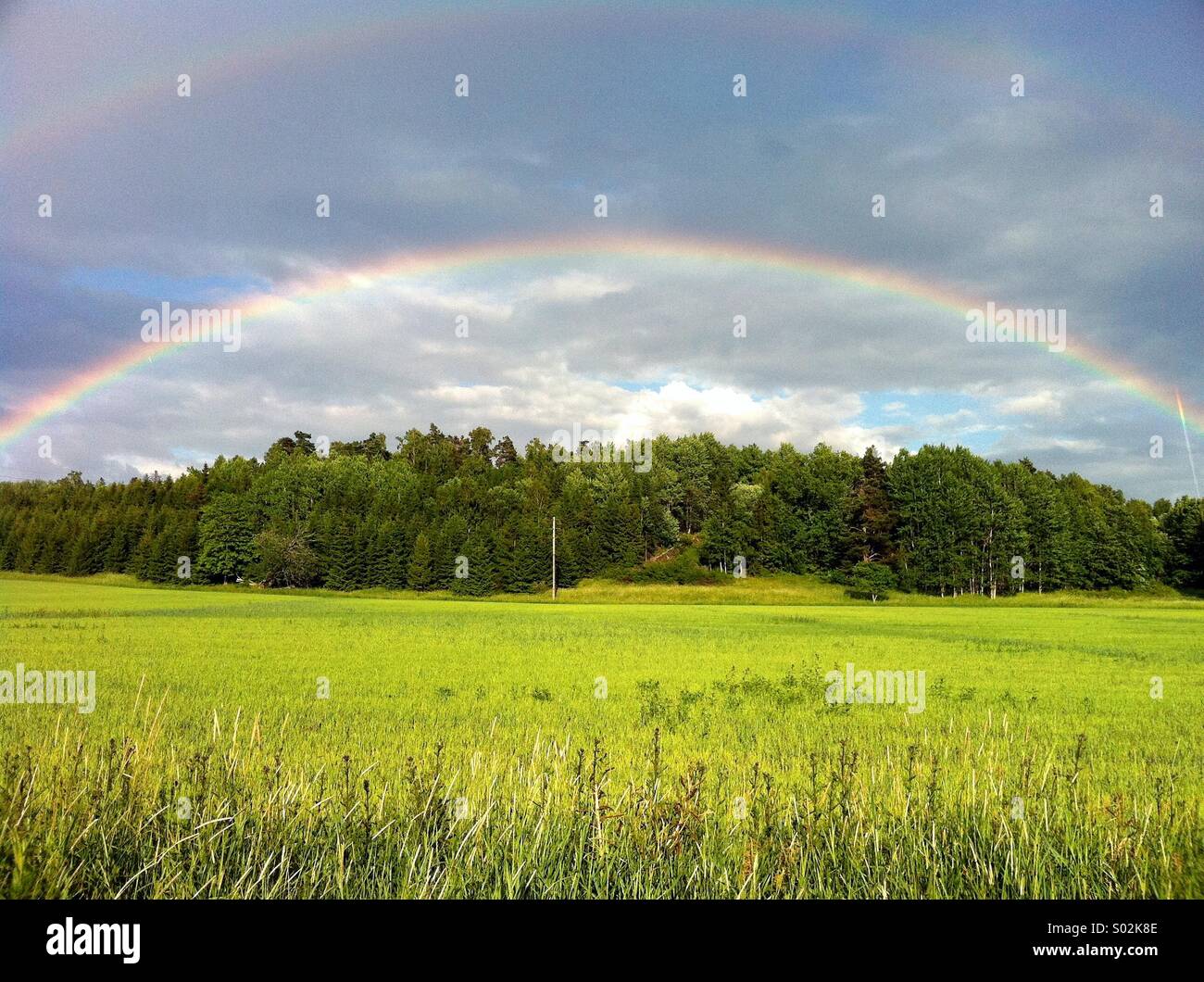 Rainbow over Fields Stock Photo - Alamy