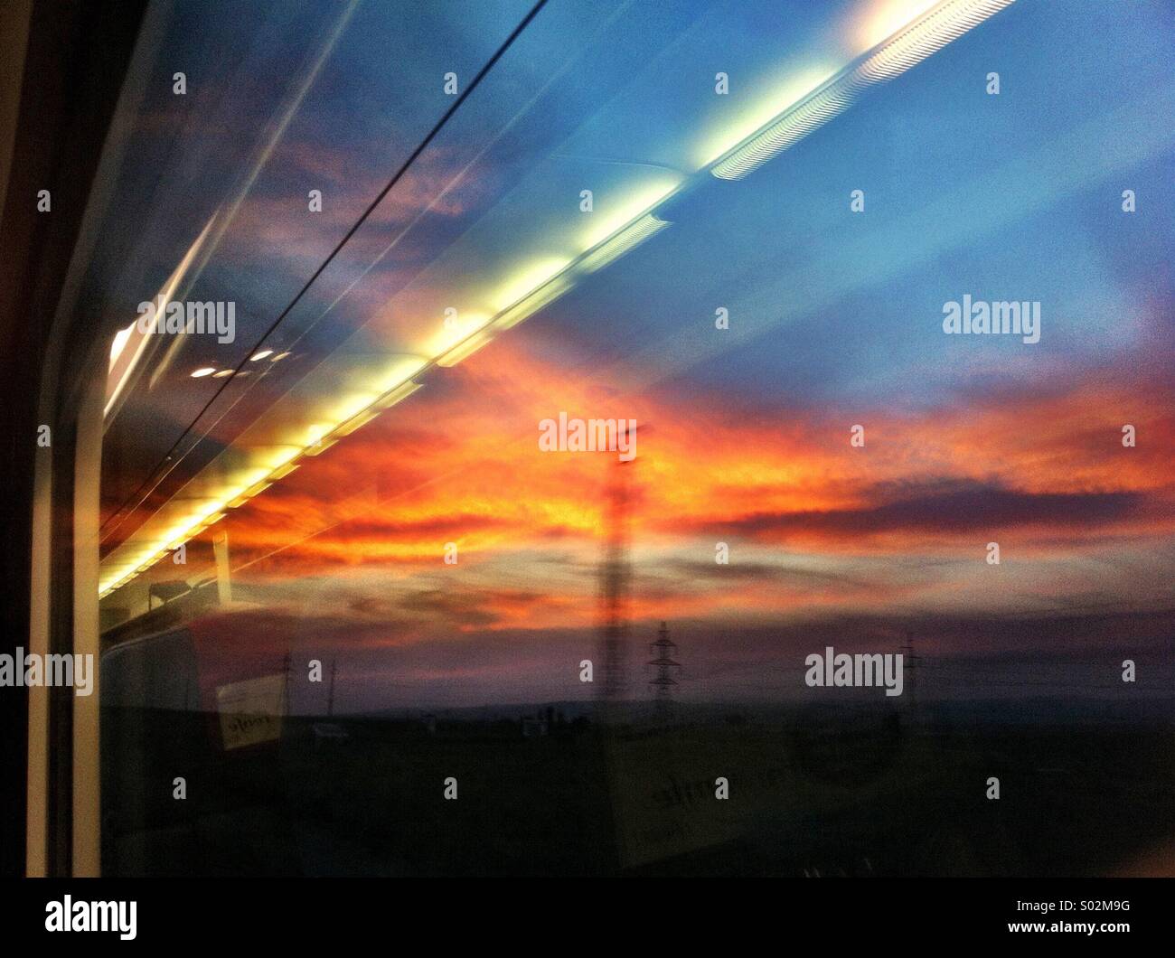 Dramatic sunset sky through a train window Stock Photo - Alamy