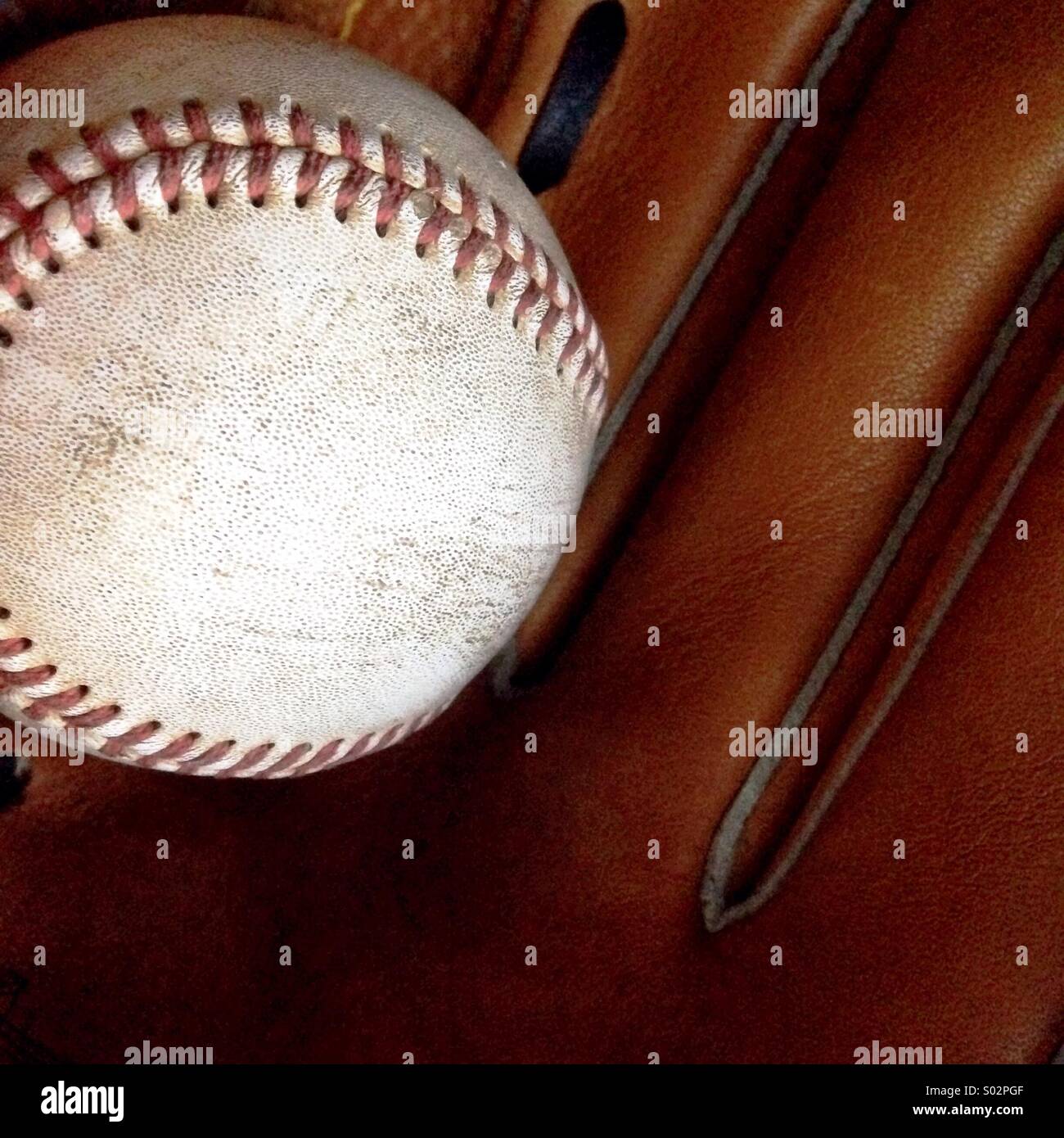 Worn baseball and glove Stock Photo - Alamy