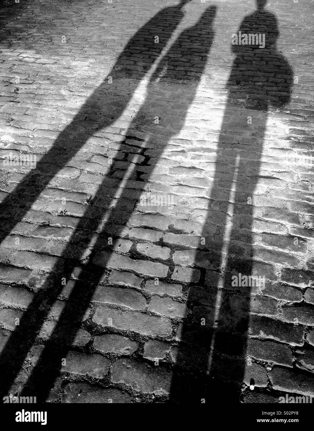 Three long shadows Stock Photo - Alamy