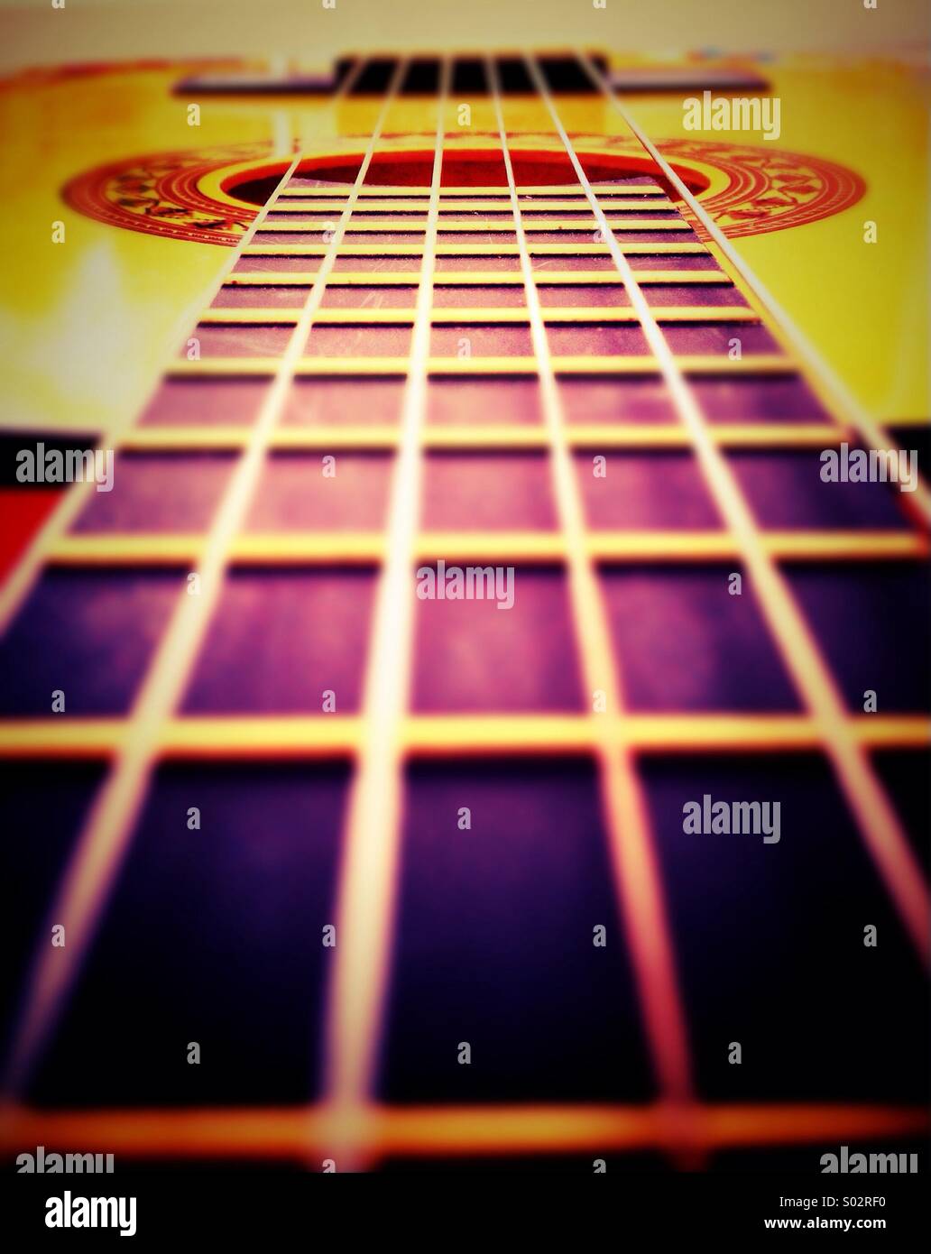 Looking down neck of acoustic guitar Stock Photo - Alamy