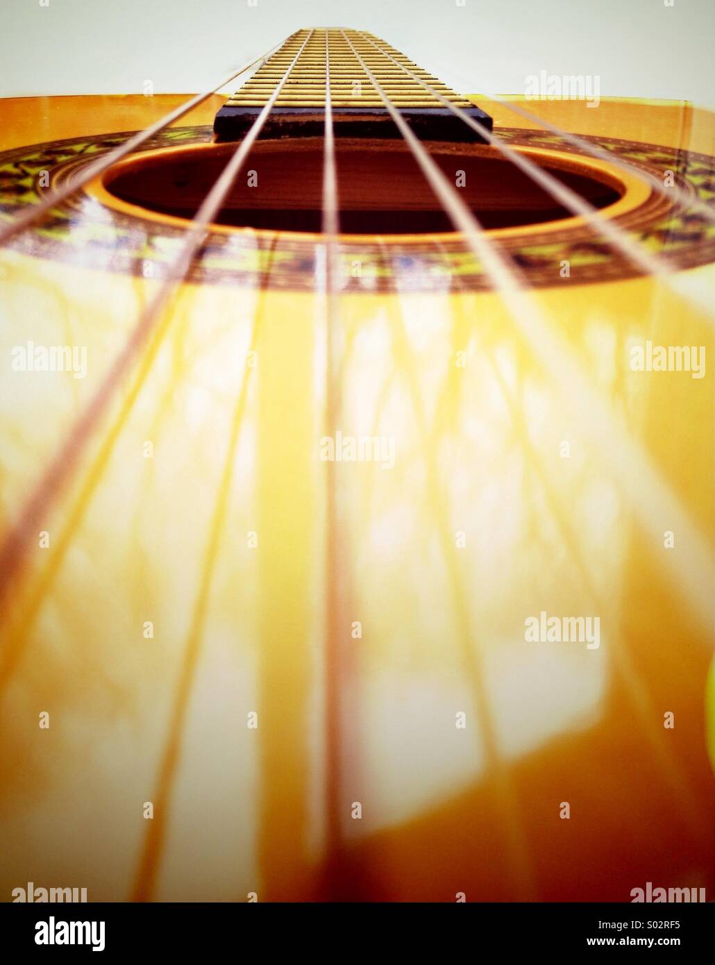 Guitar strings and reflections in body of guitar Stock Photo - Alamy