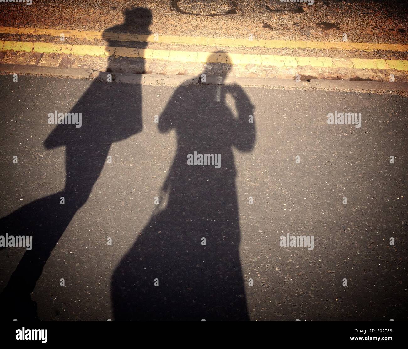 Shadows two people walking hi-res stock photography and images - Alamy