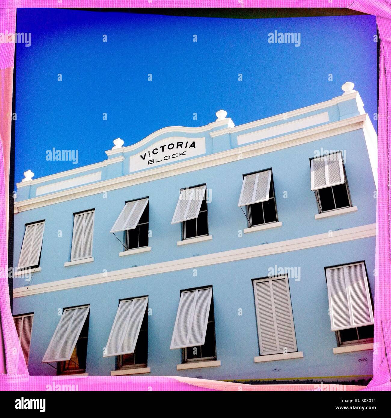 Victoria Block, a vibrant blue building among the colourful properties ...