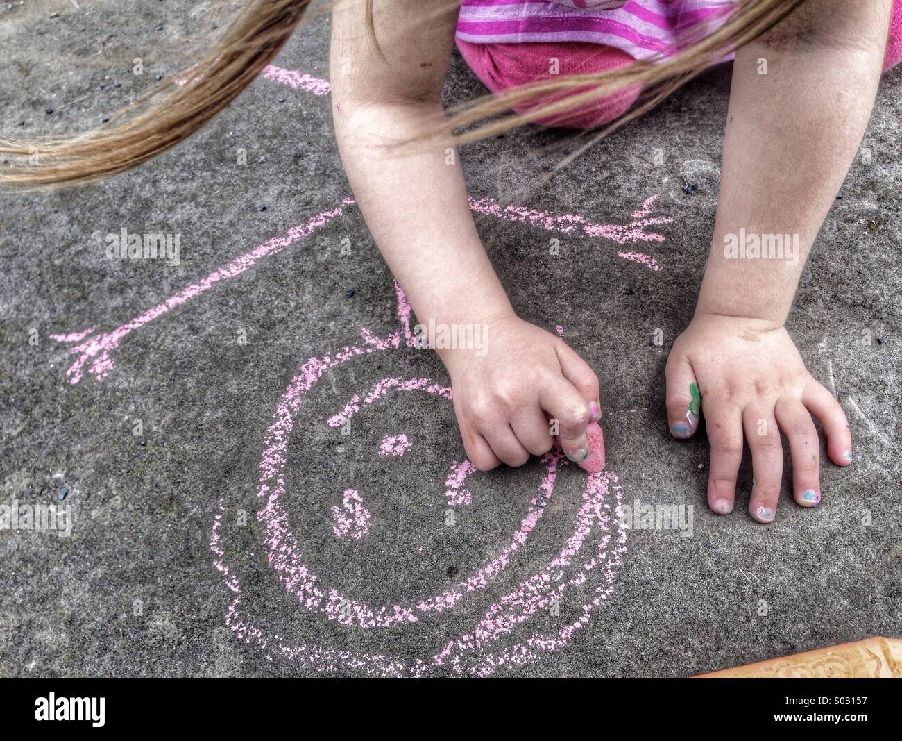 Toddler Caucasian girl draws stick figure with chalk Stock Photo - Alamy