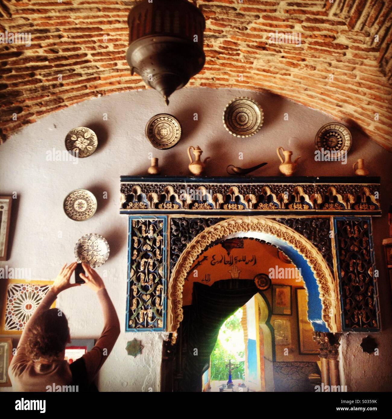 A female tourist takes pictures of an Al-Andalus door, made in the ...