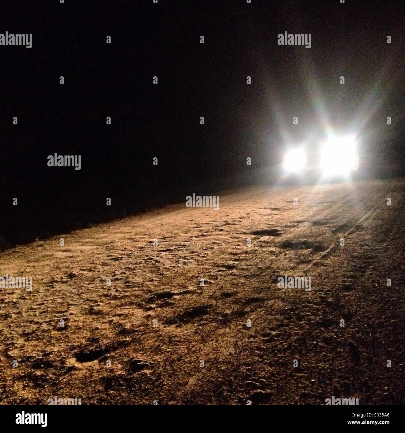 A car drives at night in a dirt road in Prado del Rey, Cadiz province ...