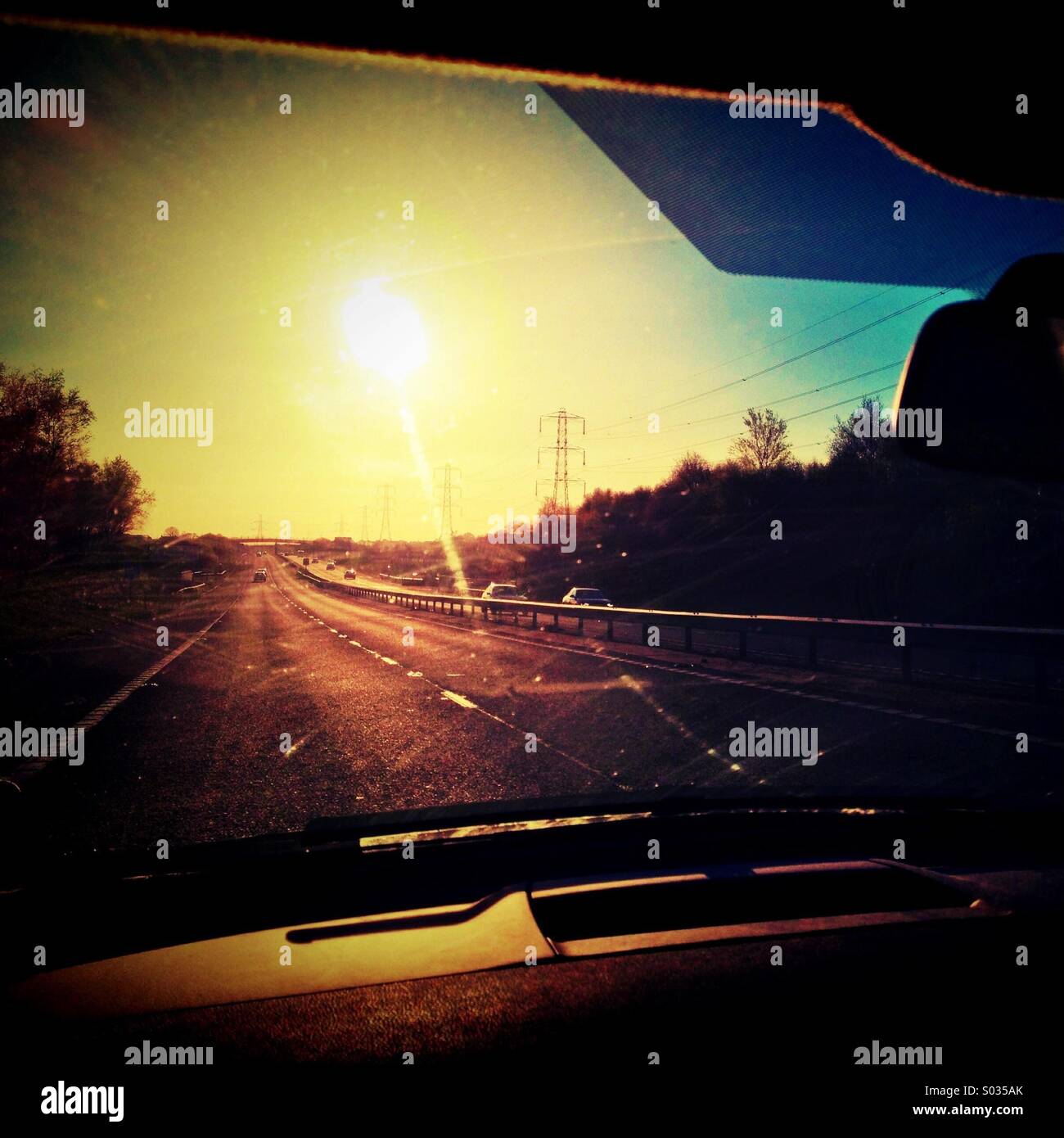 Motorway driving into the sun Stock Photo - Alamy
