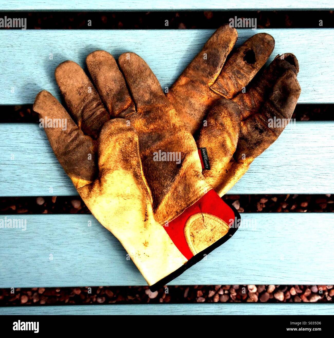Gardening Gloves on Bench Stock Photo - Alamy
