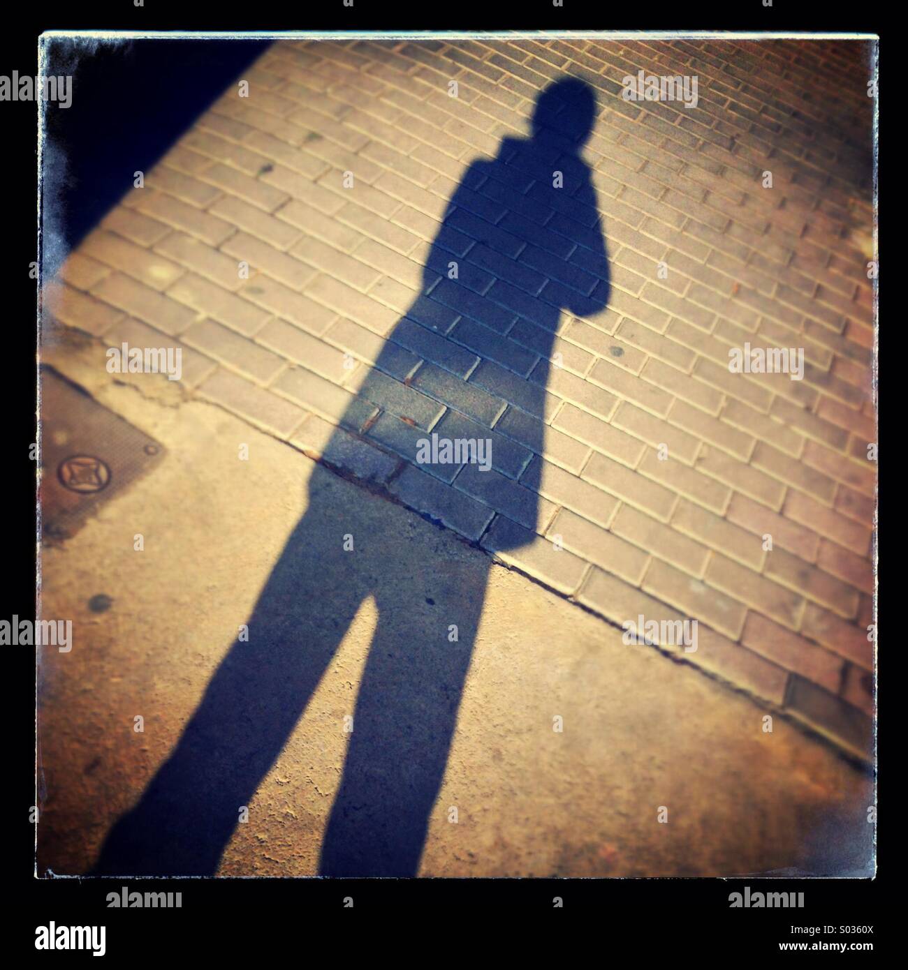 Shadow of person on pavement sidewalk Stock Photo - Alamy