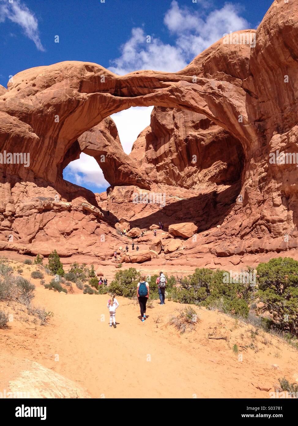 Hikers at Double Arch, Arches NP, Utah Stock Photo - Alamy