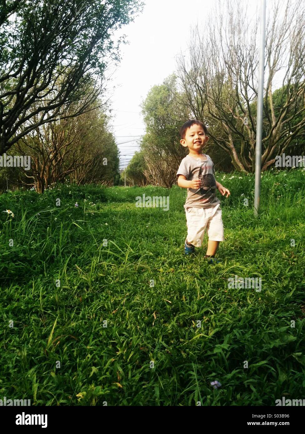 An Asia boy running in the forest Stock Photo - Alamy