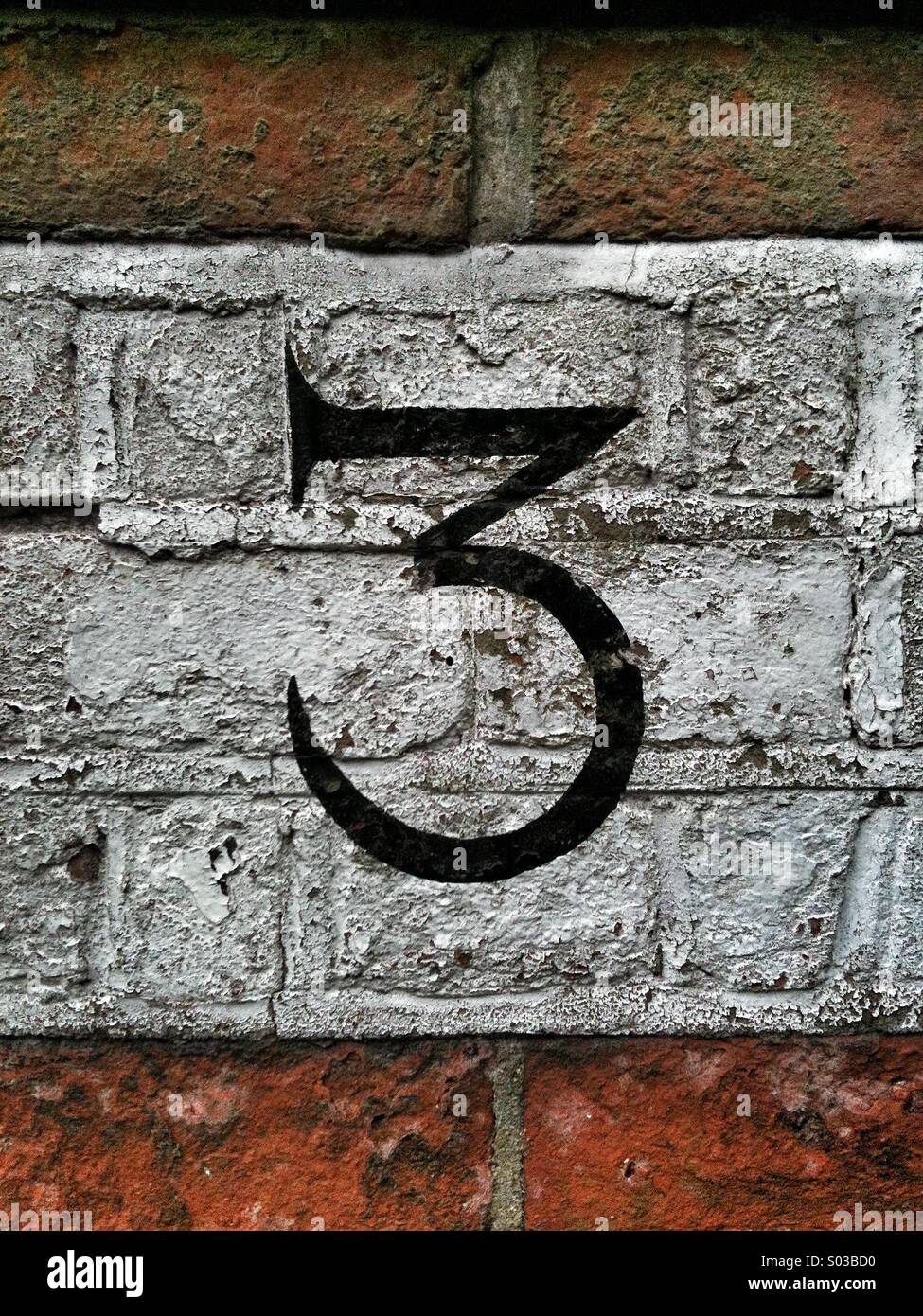 A hand painted numeral 3 on a brick wall Stock Photo - Alamy
